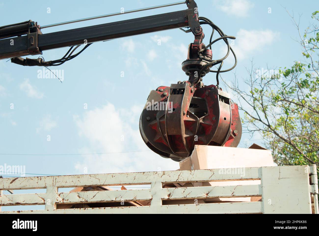 garbage truck with manual hydraulic. Claws of mechanical moving arm ...