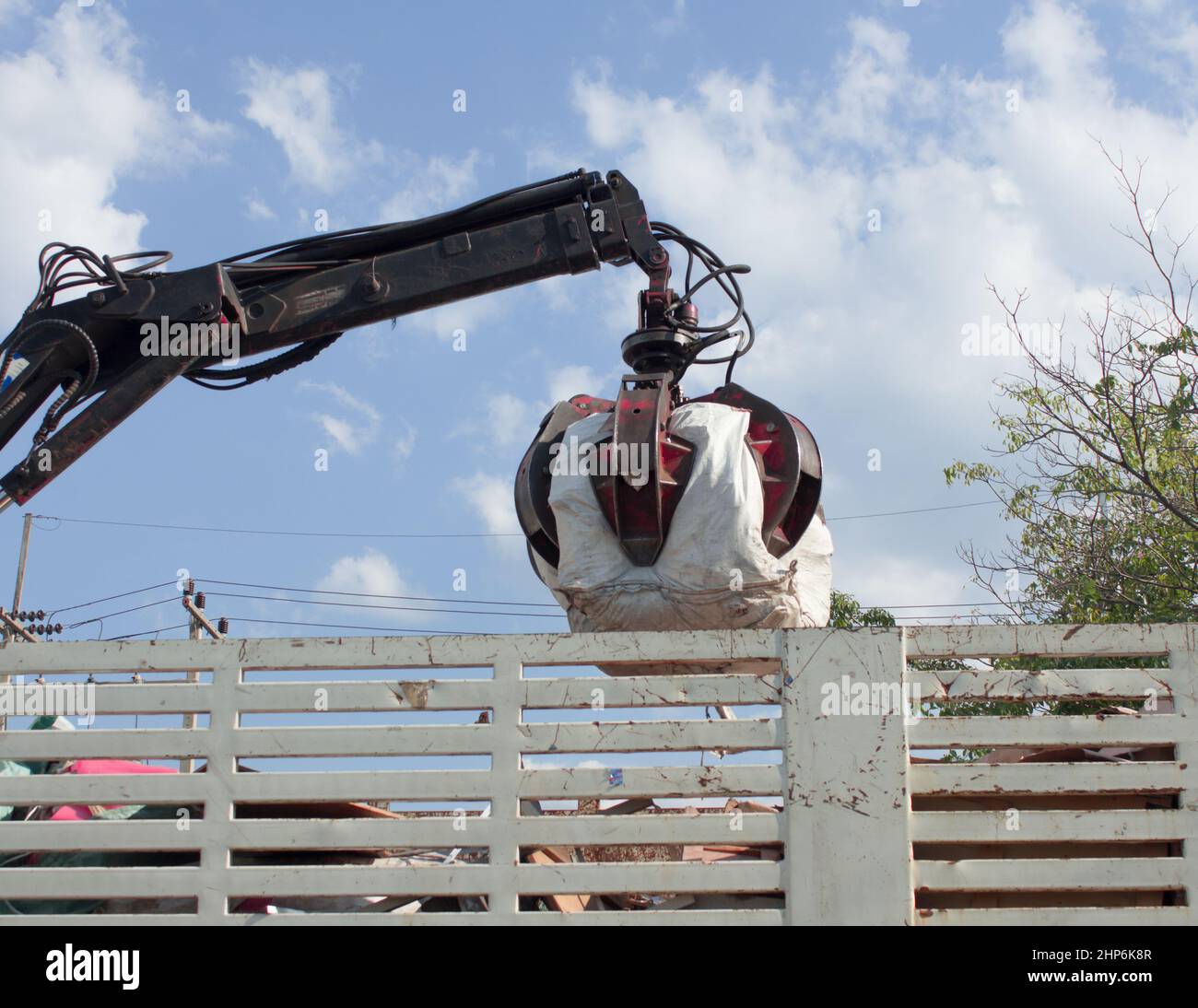 garbage truck with manual hydraulic. Claws of mechanical moving arm ...