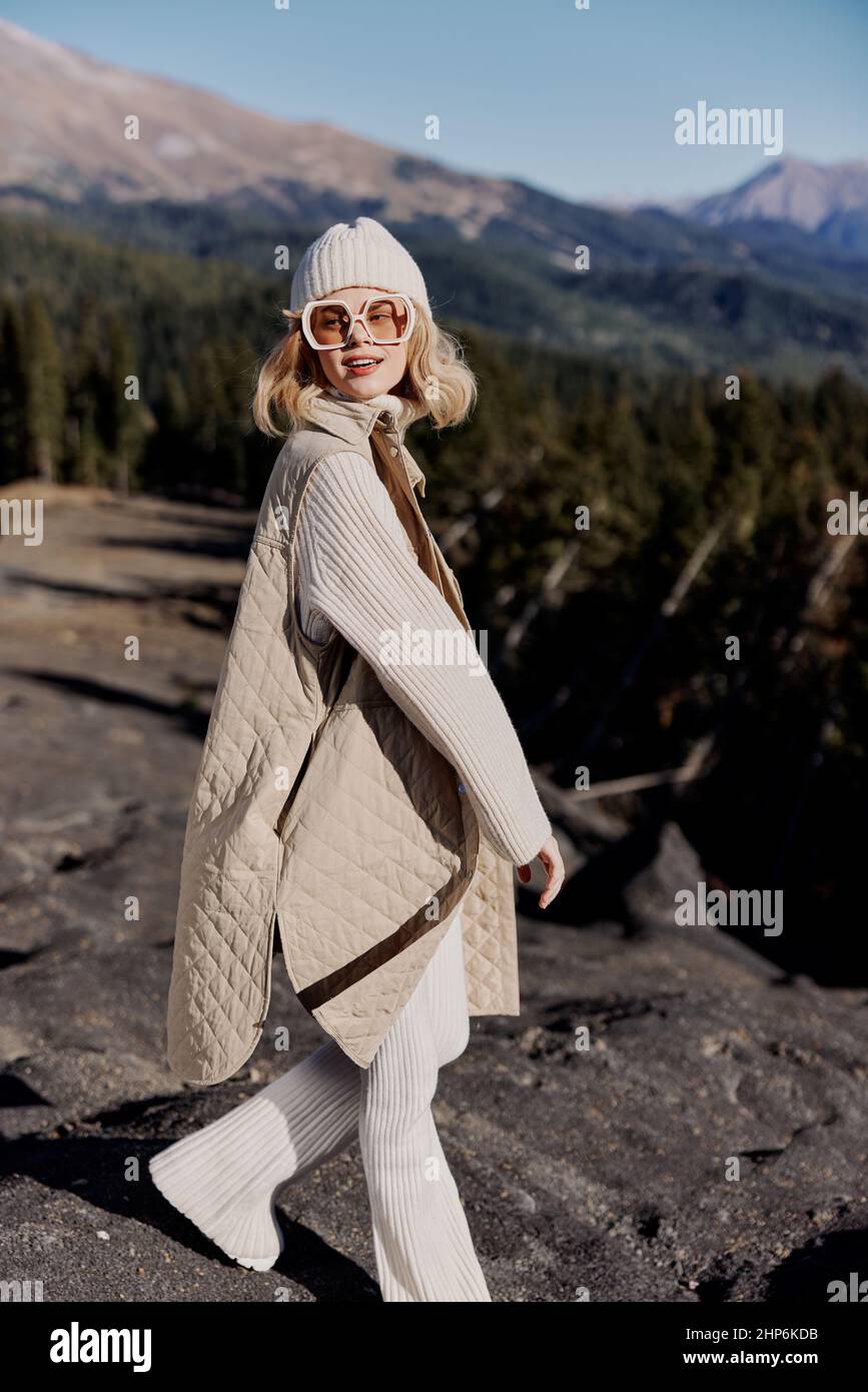 tourist in autumn clothes stands on a rock blue sky relaxation Stock ...