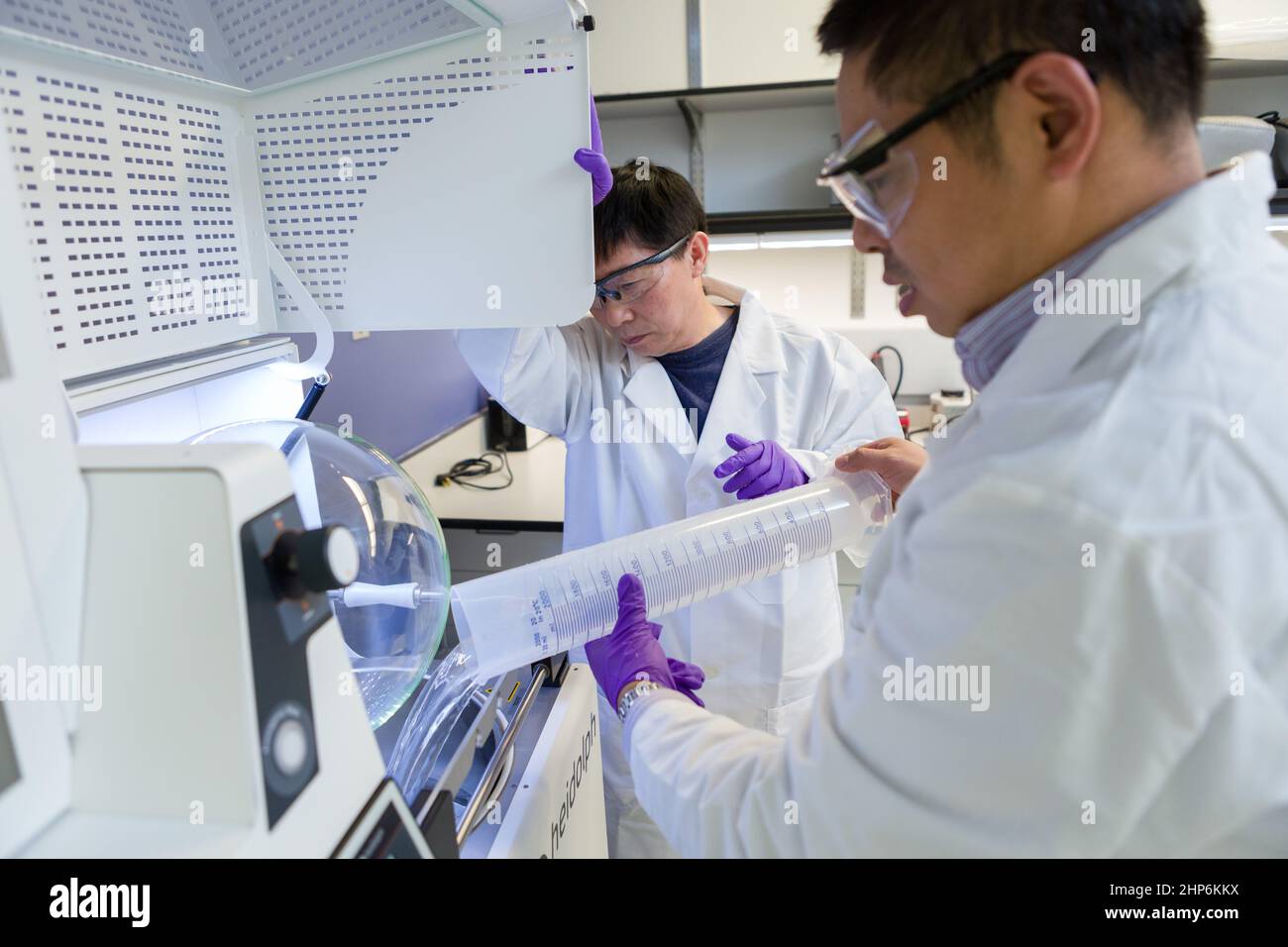 Junfeng Huang and Victor Ding operate the rotary evaporator in the ...