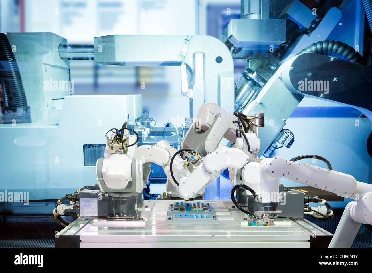 Industrial automation robotic teamwork working with circuit board on ...