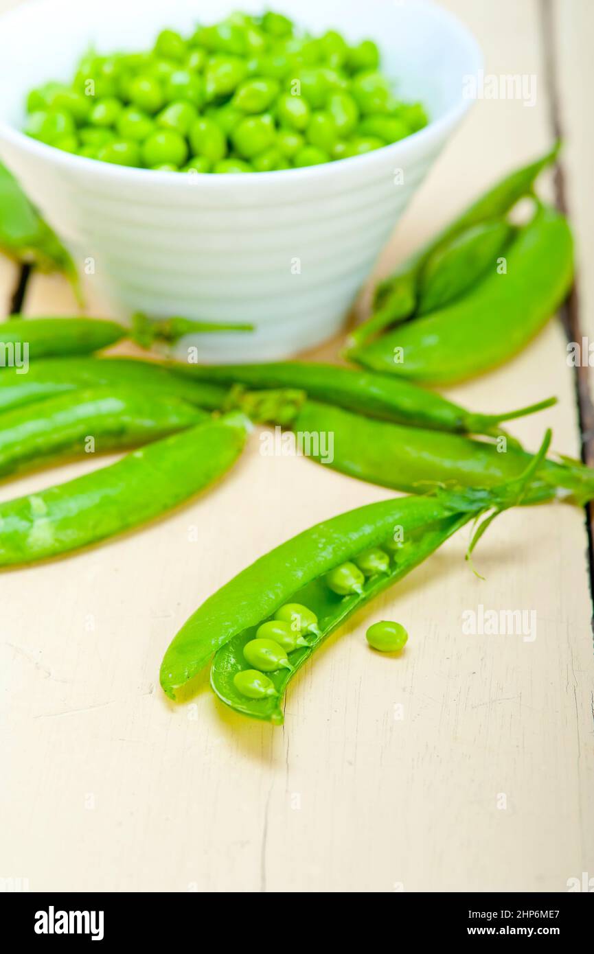 hearthy fresh green peas over a rustic wood table Stock Photo - Alamy