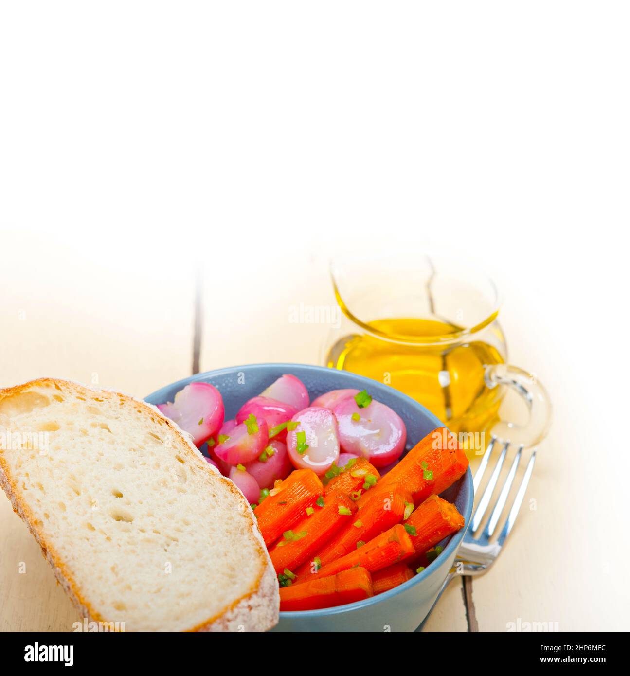 bowl of steamed root vegetable on a rustic white wood table Stock Photo ...