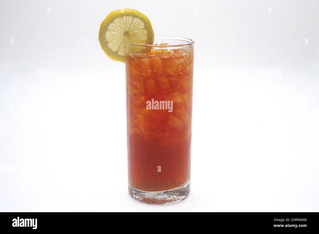 A tall glass of iced tea with a slice of lemon for garnish Stock Photo ...