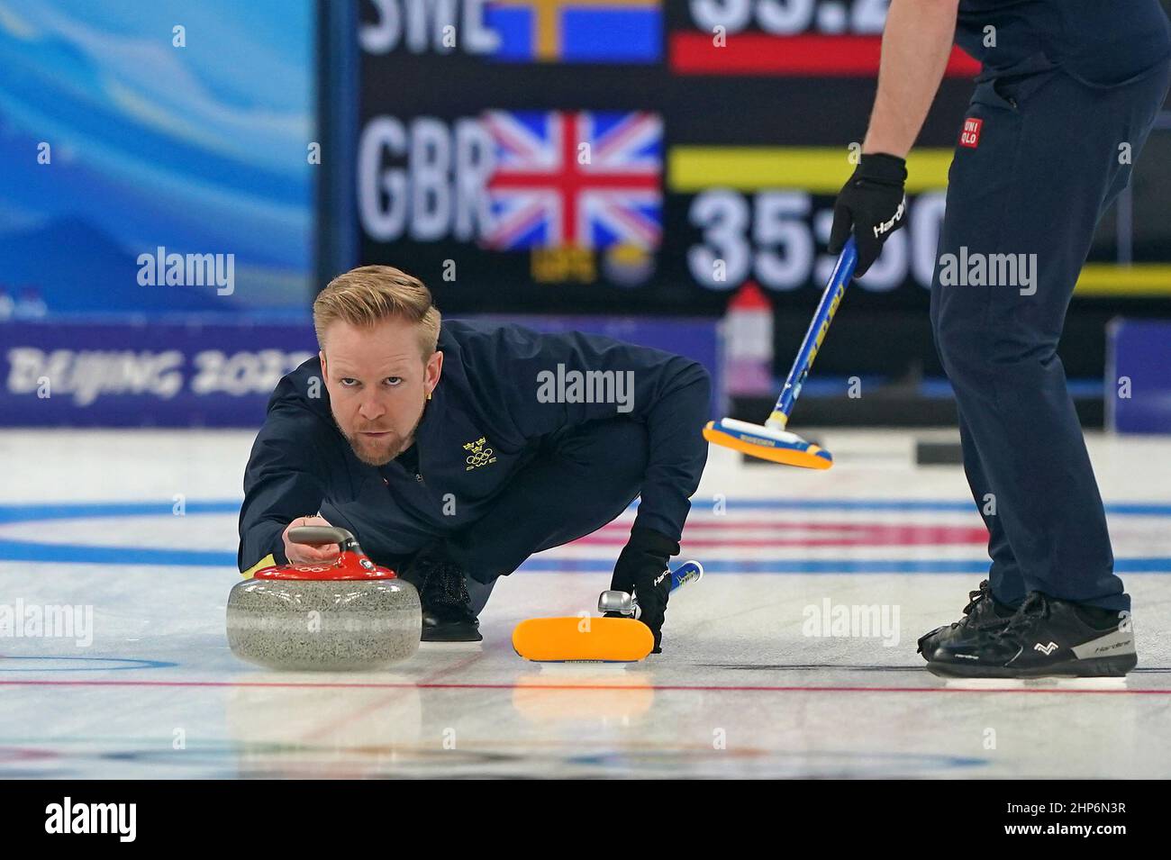 Sweden's Niklas Edin releases the stone in the Men's Gold Medal game ...