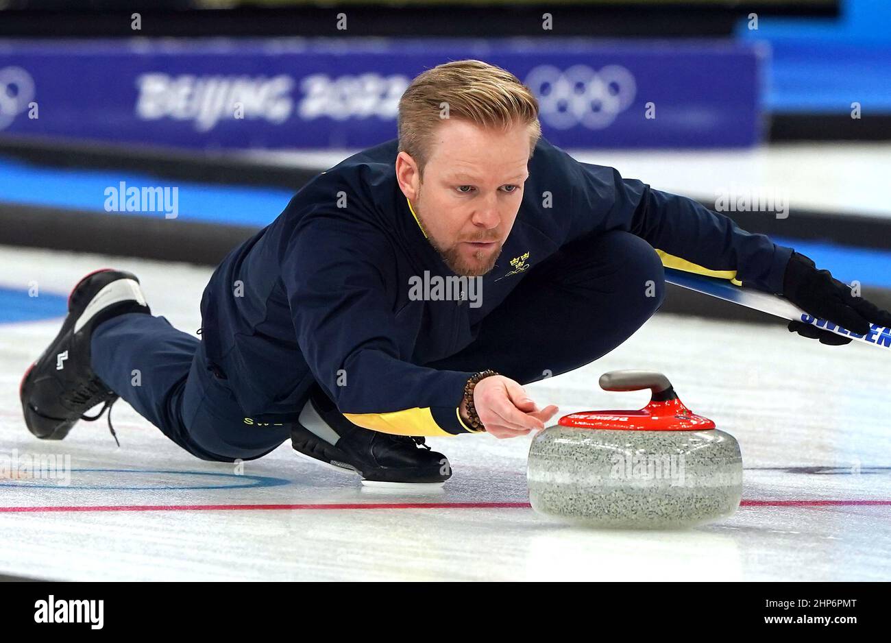 Sweden's Niklas Edin releases the stone in the Men's Gold Medal game ...