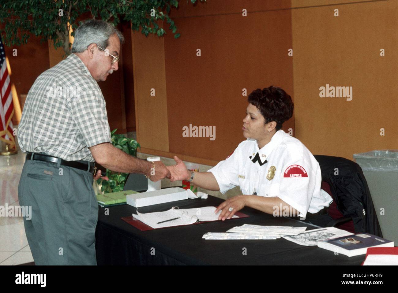 A security guard checks identification at Warren G. Magnuson Clinical ...