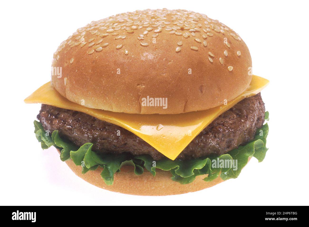A single hamburger on a bun with cheese and lettuce ca. 1994 Stock ...