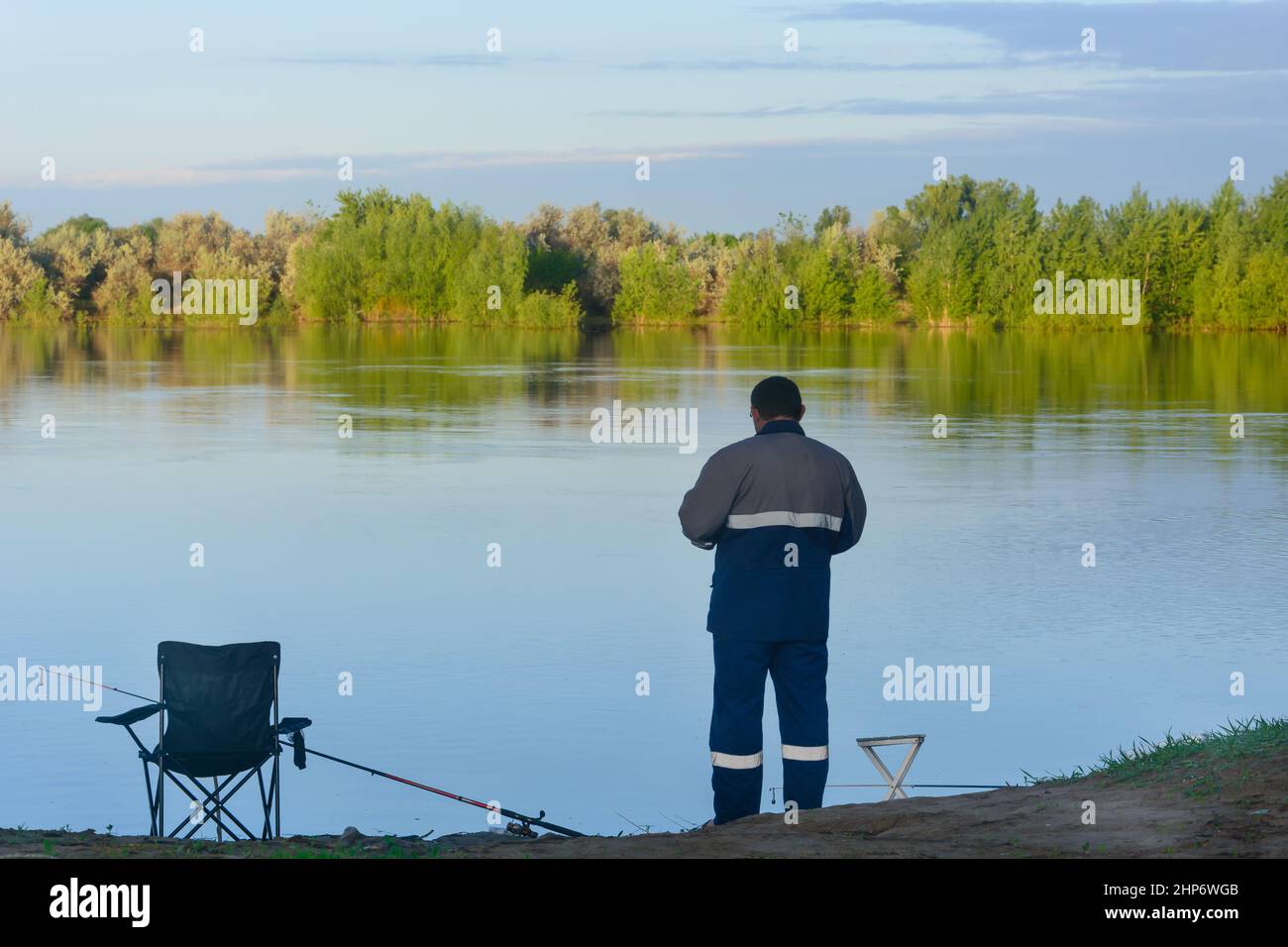 Back view man sitting fishing hi-res stock photography and images - Alamy