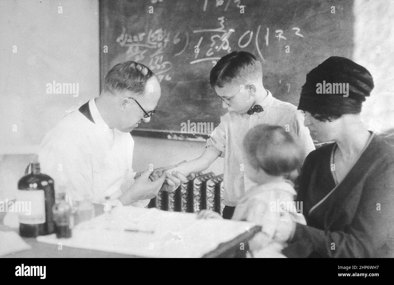 Young boy receiving the Schick test from a doctor (the test is a ...