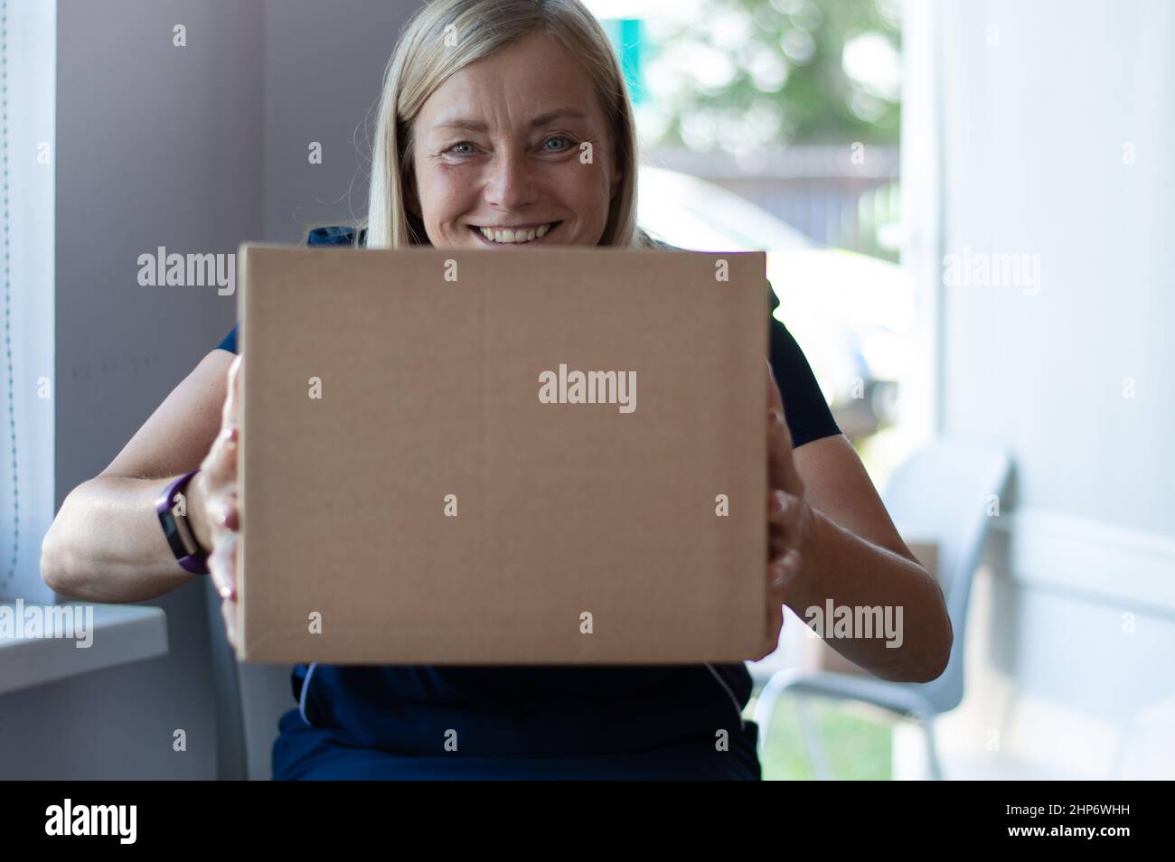 Mockup friendly parcel delivery. Woman happy holding a parcel Stock ...