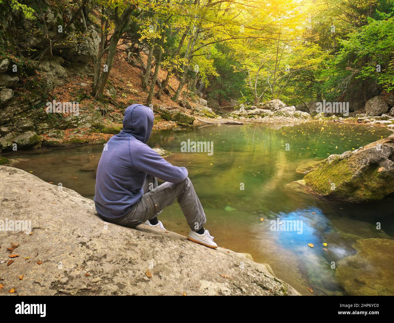 Man in autumn forest and river lake. Landscape and nature scene Stock ...