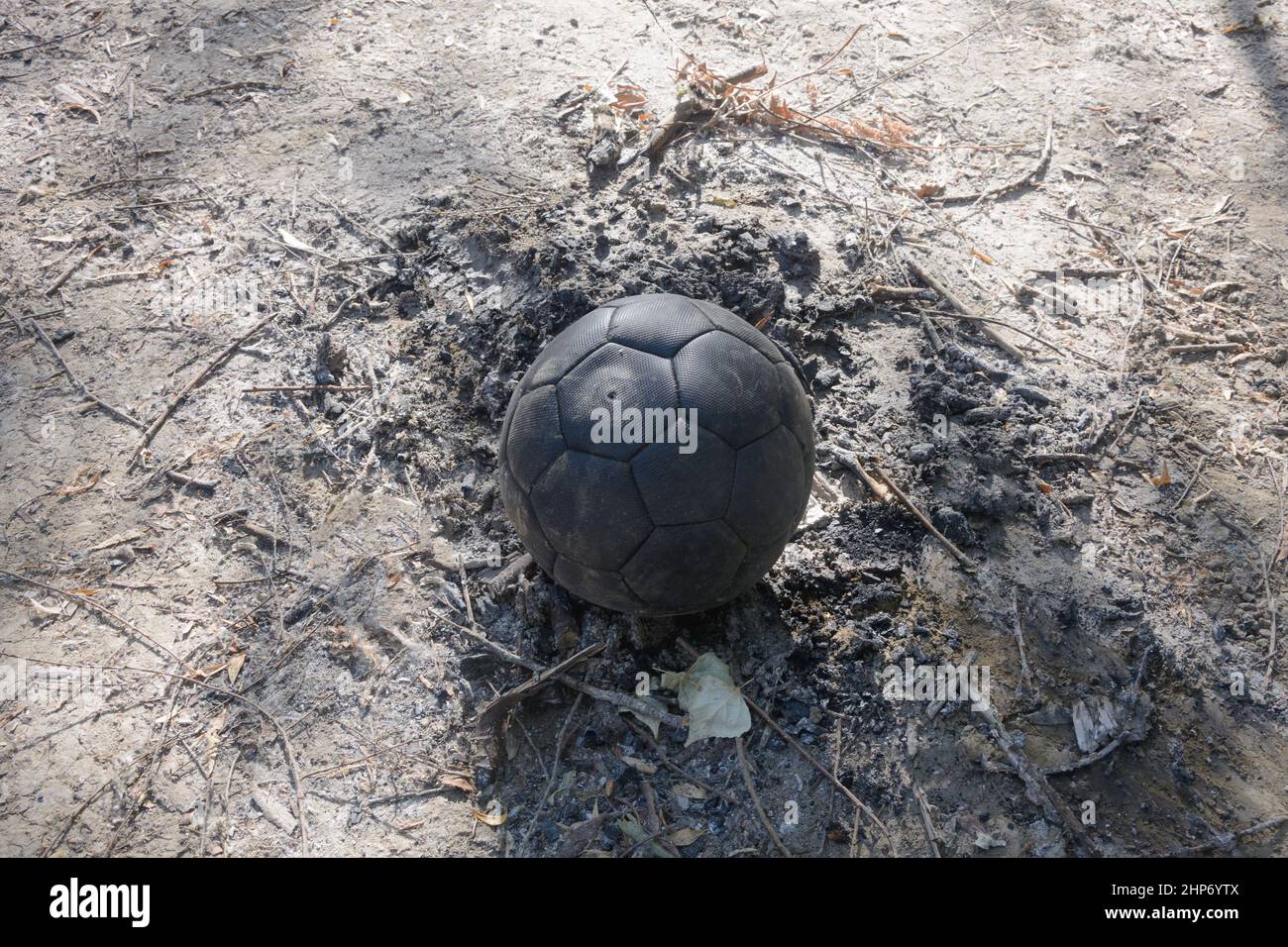 Burnt soccer ball in the ashes of a fire Stock Photo - Alamy