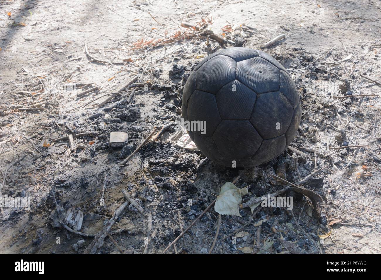 Black soccer ball burned up in the fire Stock Photo - Alamy