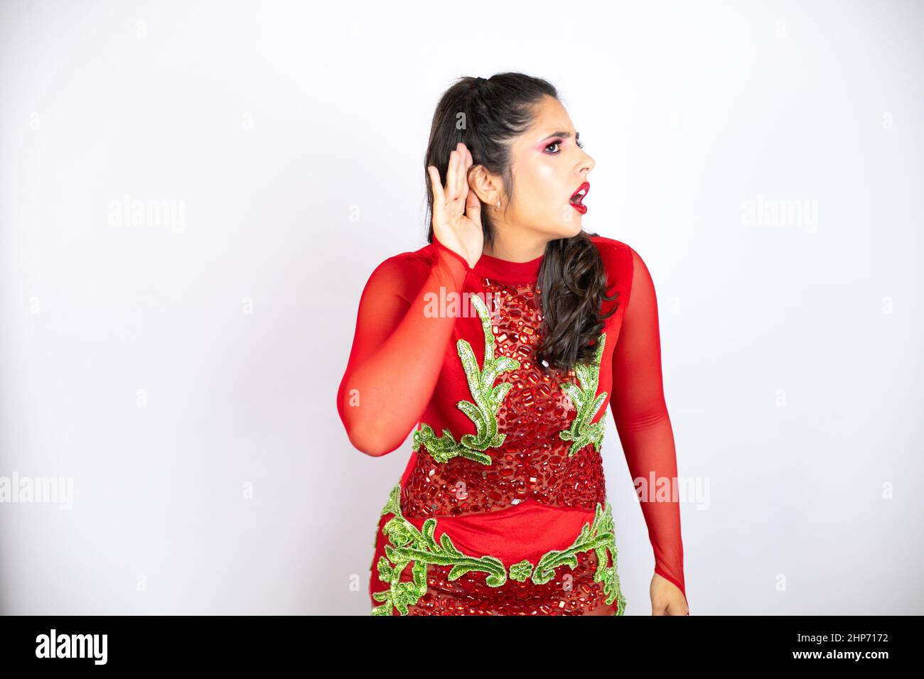 Young beautiful woman wearing carnival costume over isolated white ...