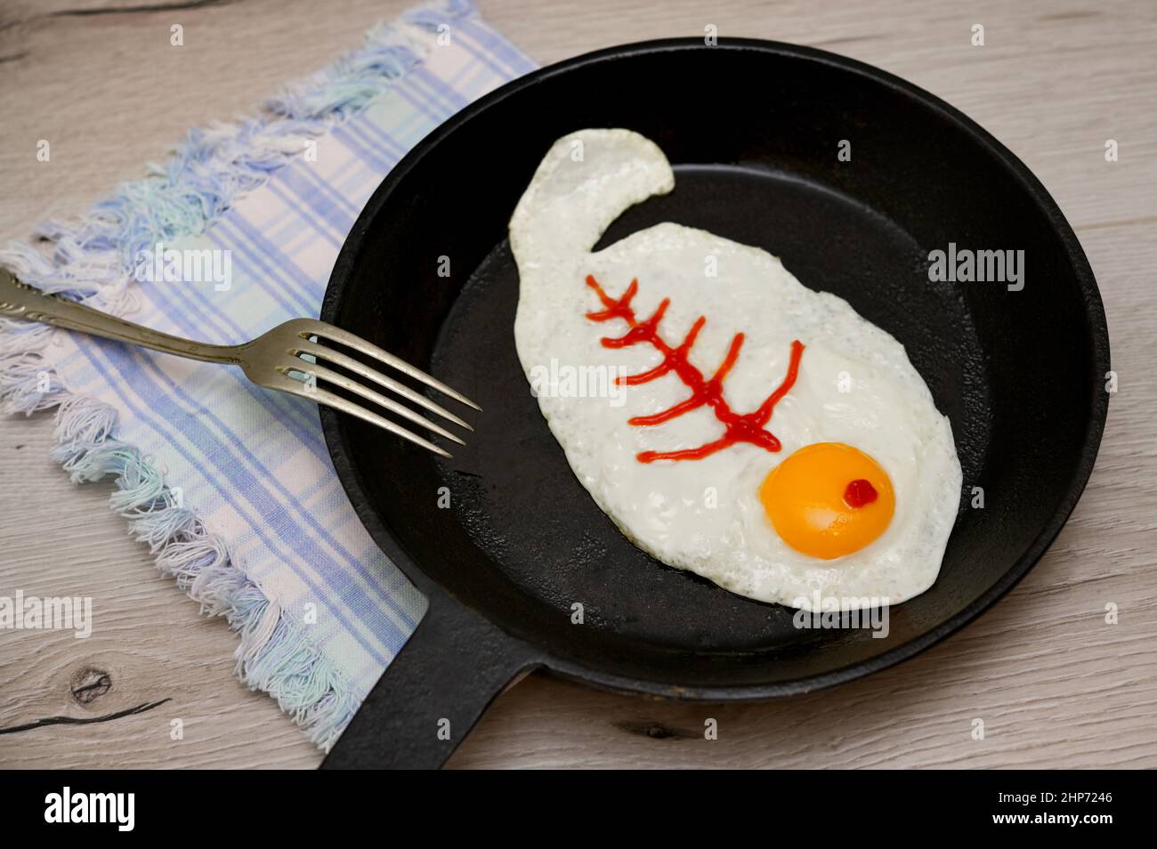 Abstract breakfast fried egg fish shape with Fish skeleton Stock Photo ...