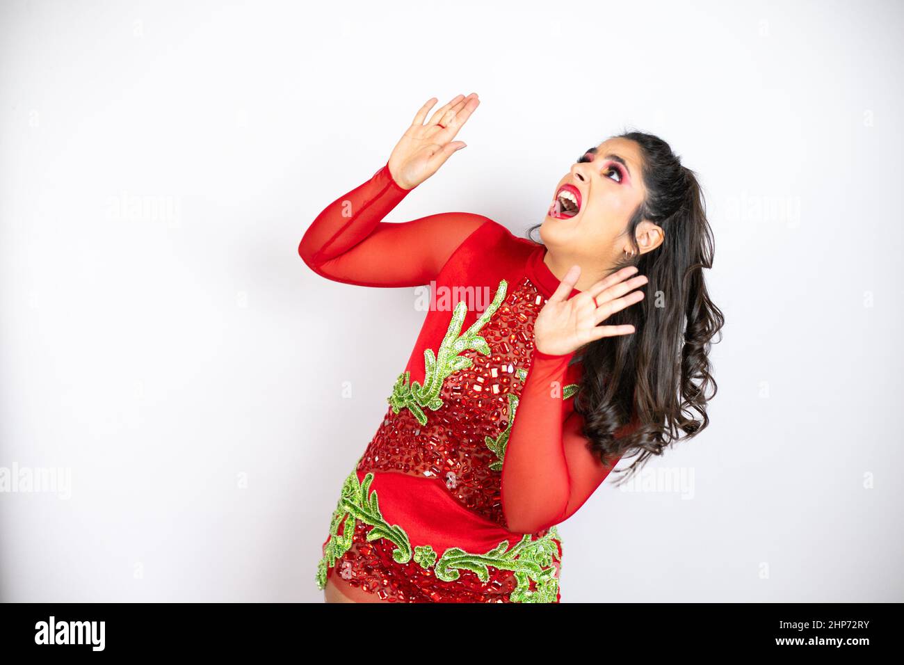 Young beautiful woman wearing carnival costume over isolated white ...