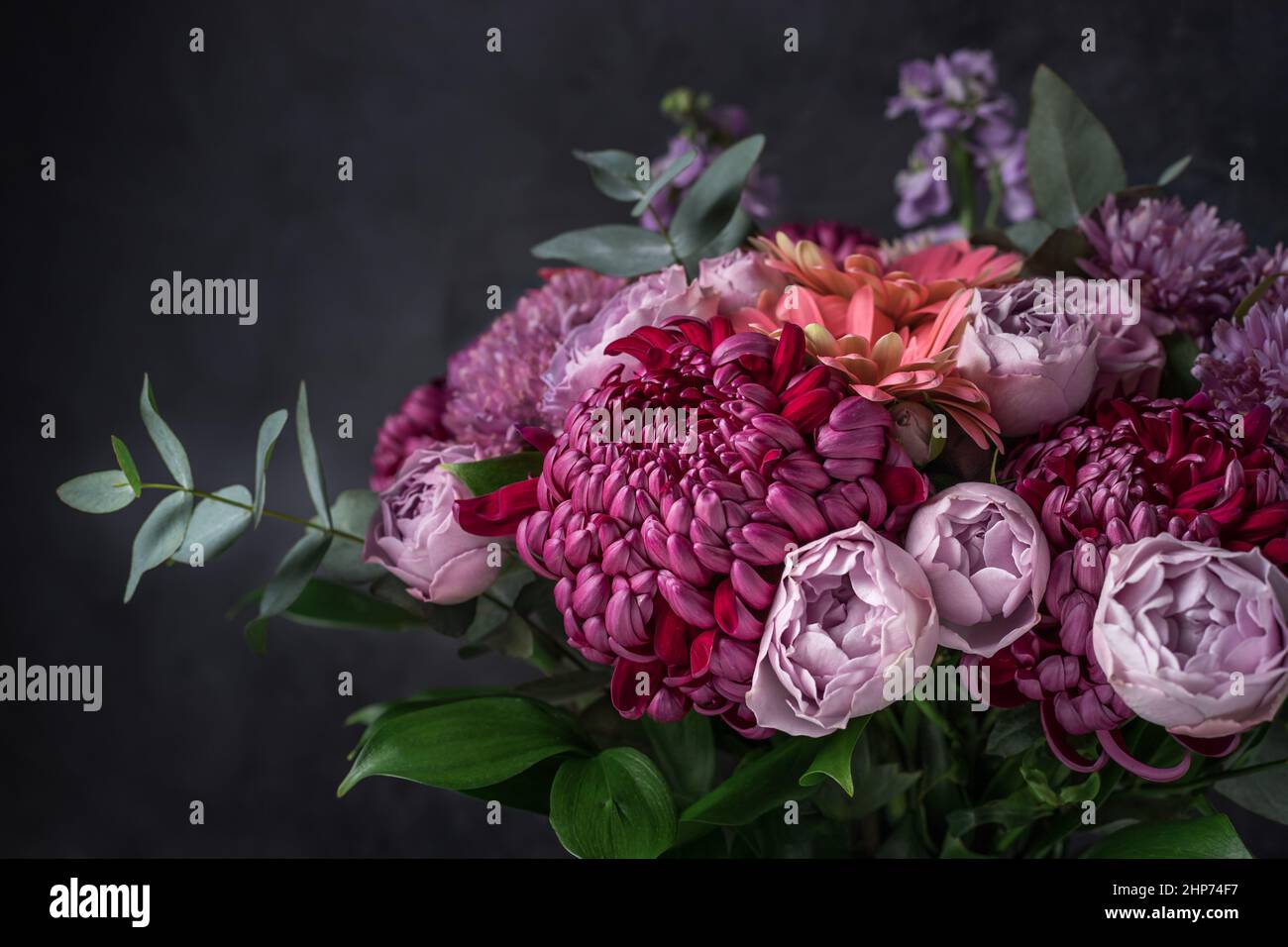 Flower arrangement of purple chrysanthemums, roses and eucalyptus ...