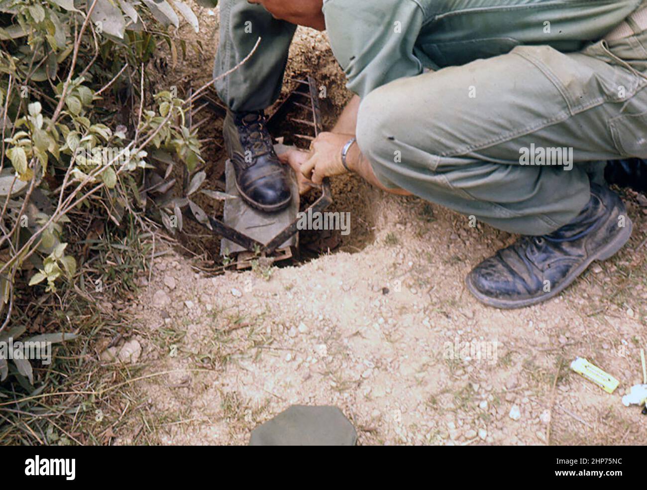 One man helping another man out of the scissors device - March 1966 ...