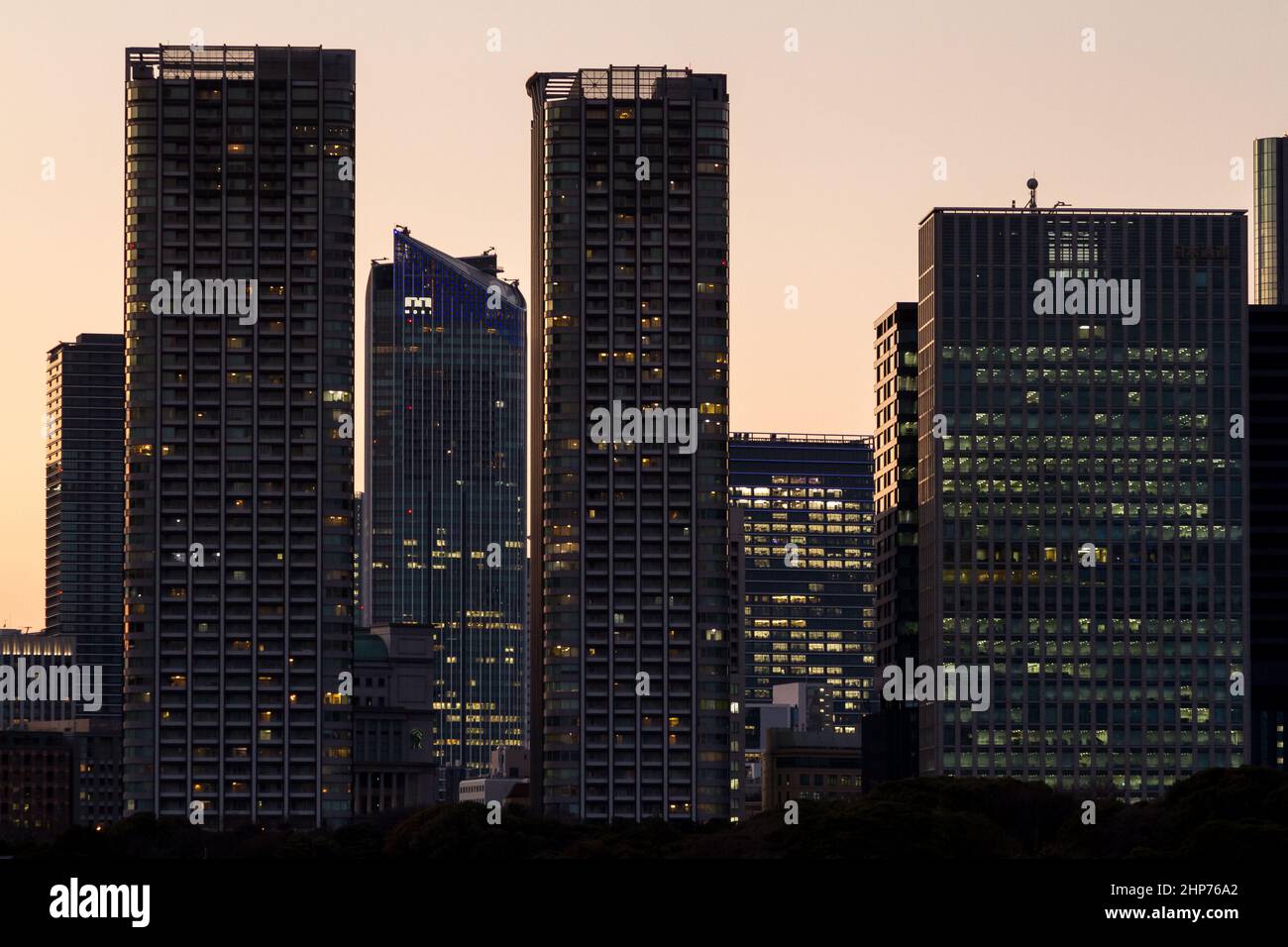 Toranomon Hills tower and other tall buildings in Tokyo at sunset ...