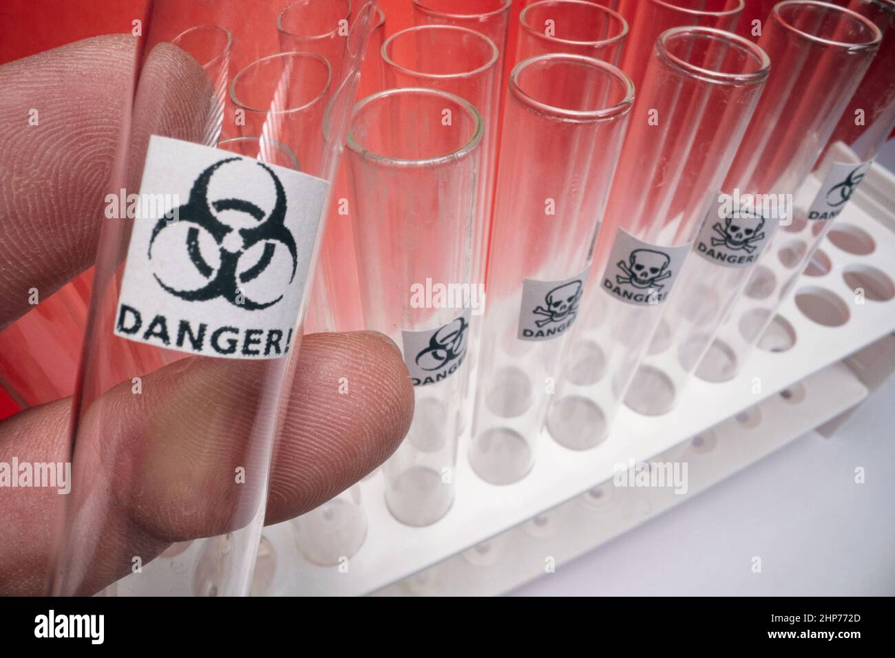 Macro view of a hand holding test tube for dangerous content in the ...