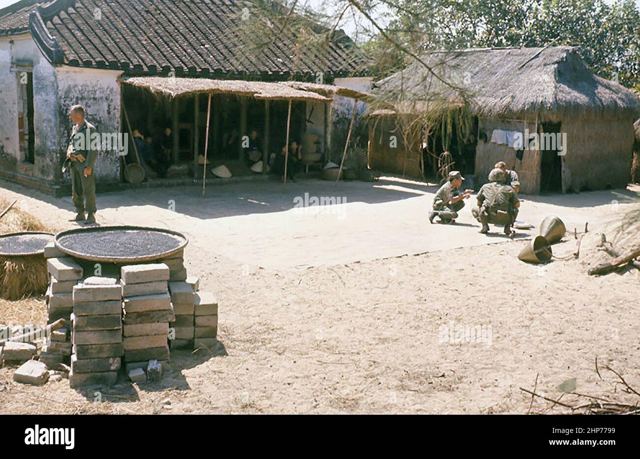 A Vietnamese farm home. The cooking is done in the straw shack to the ...