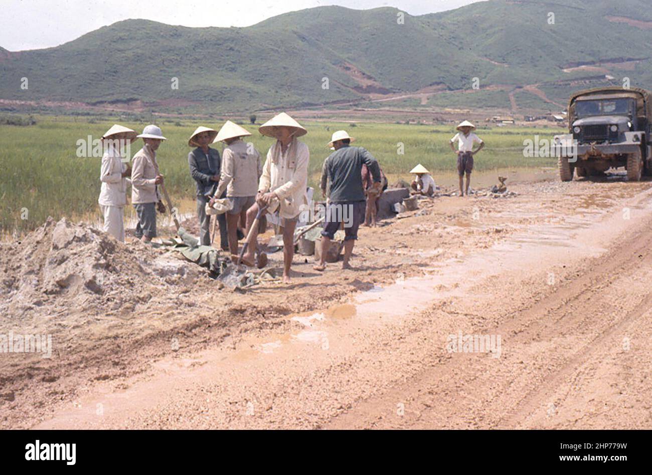 Local labor being employed to construct a culvert on the road from ...