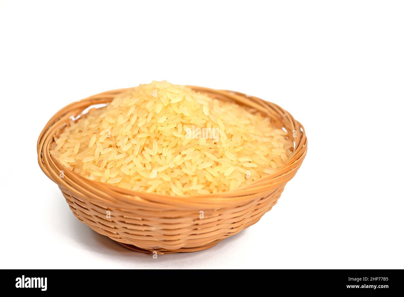 Rice grains in basket against white background Stock Photo - Alamy
