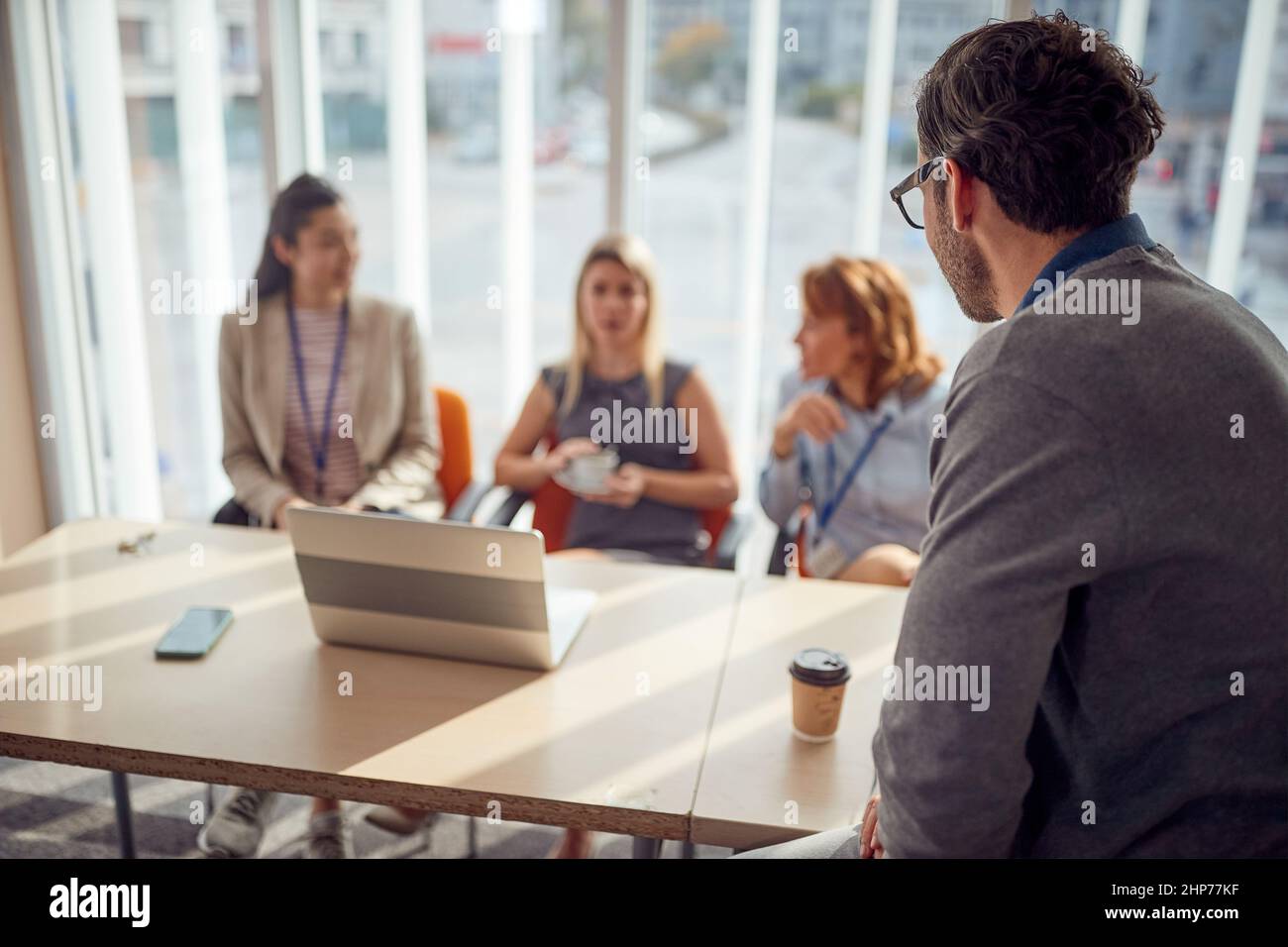 A young businessman is enjoying in a coffe break with his female ...
