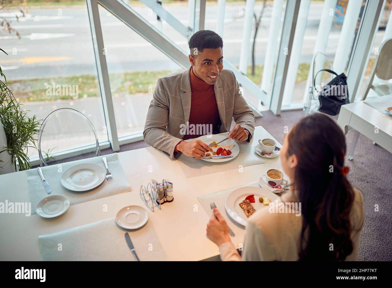 smiling colleagues having lunch at office cafeteria Stock Photo - Alamy