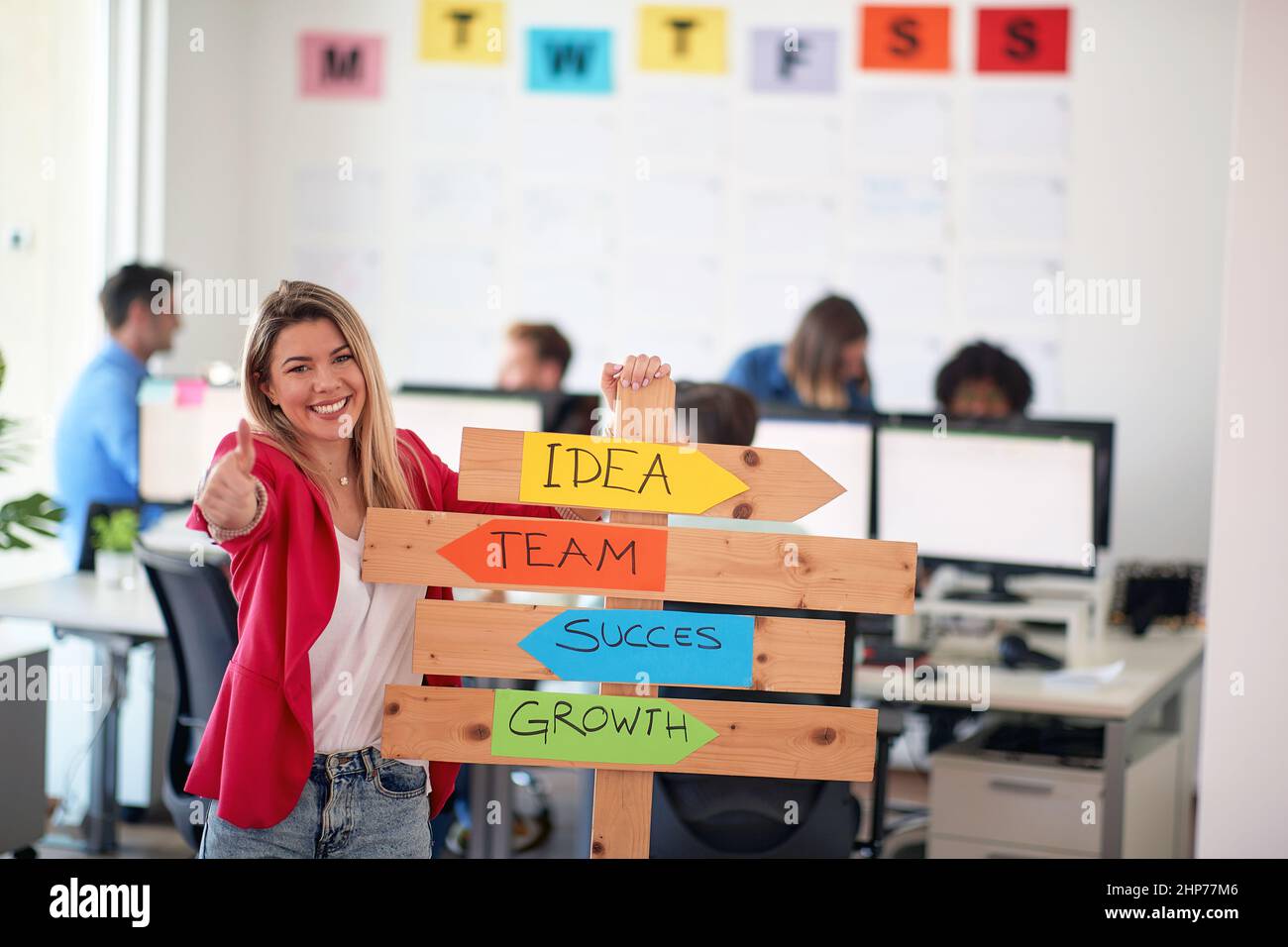 A young beautiful female office worker is in a good mood while holding ...