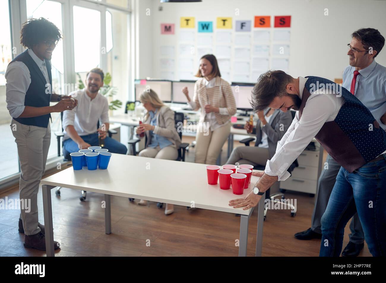 A group of cheerful employees playing in a relaxed atmosphere in the ...