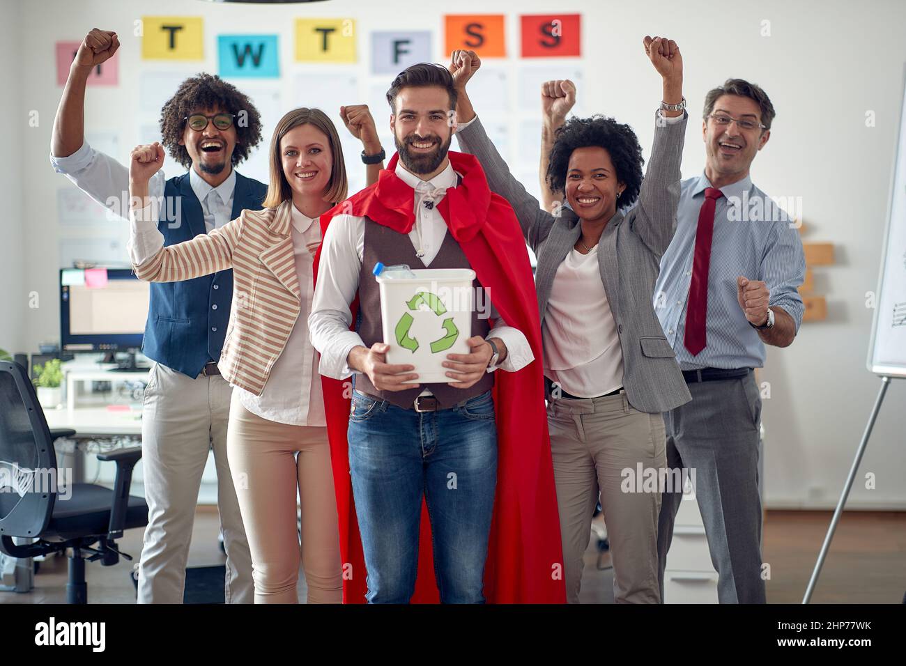 A group of cheerful employees in a pleasant atmosphere in the office is ...