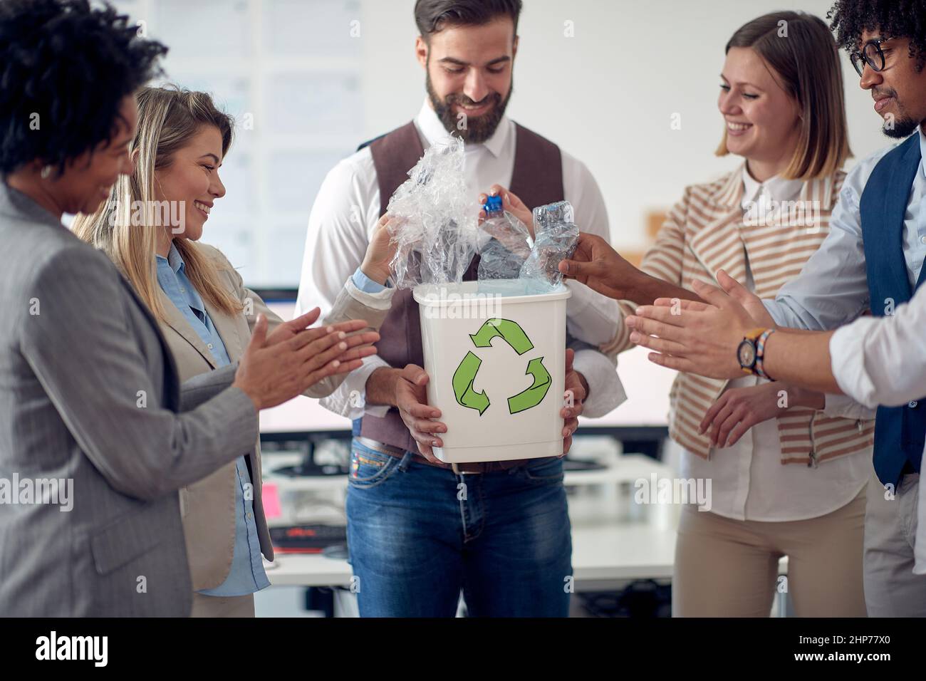A group of employees in a pleasant atmosphere in the office is doing a ...
