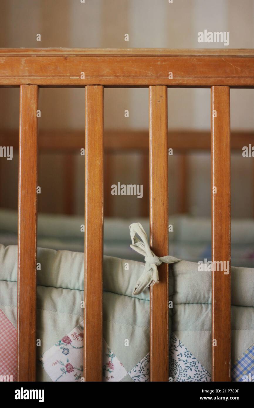 An old vintage wooden baby crib with vertical wooden slats Stock Photo ...