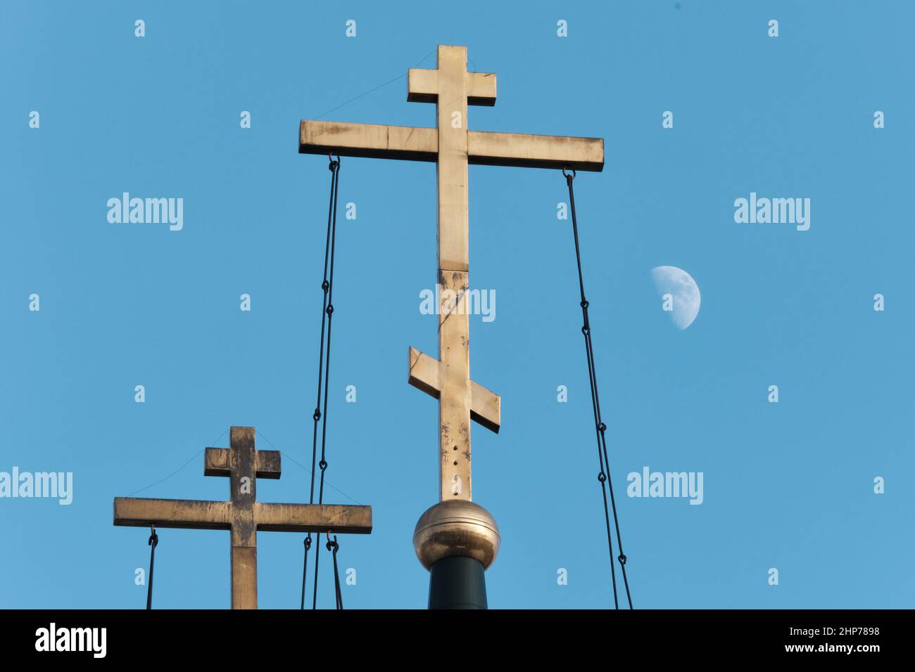 Russia. Moscow. Orthodox cross and waxing gibbous moon in daylight ...