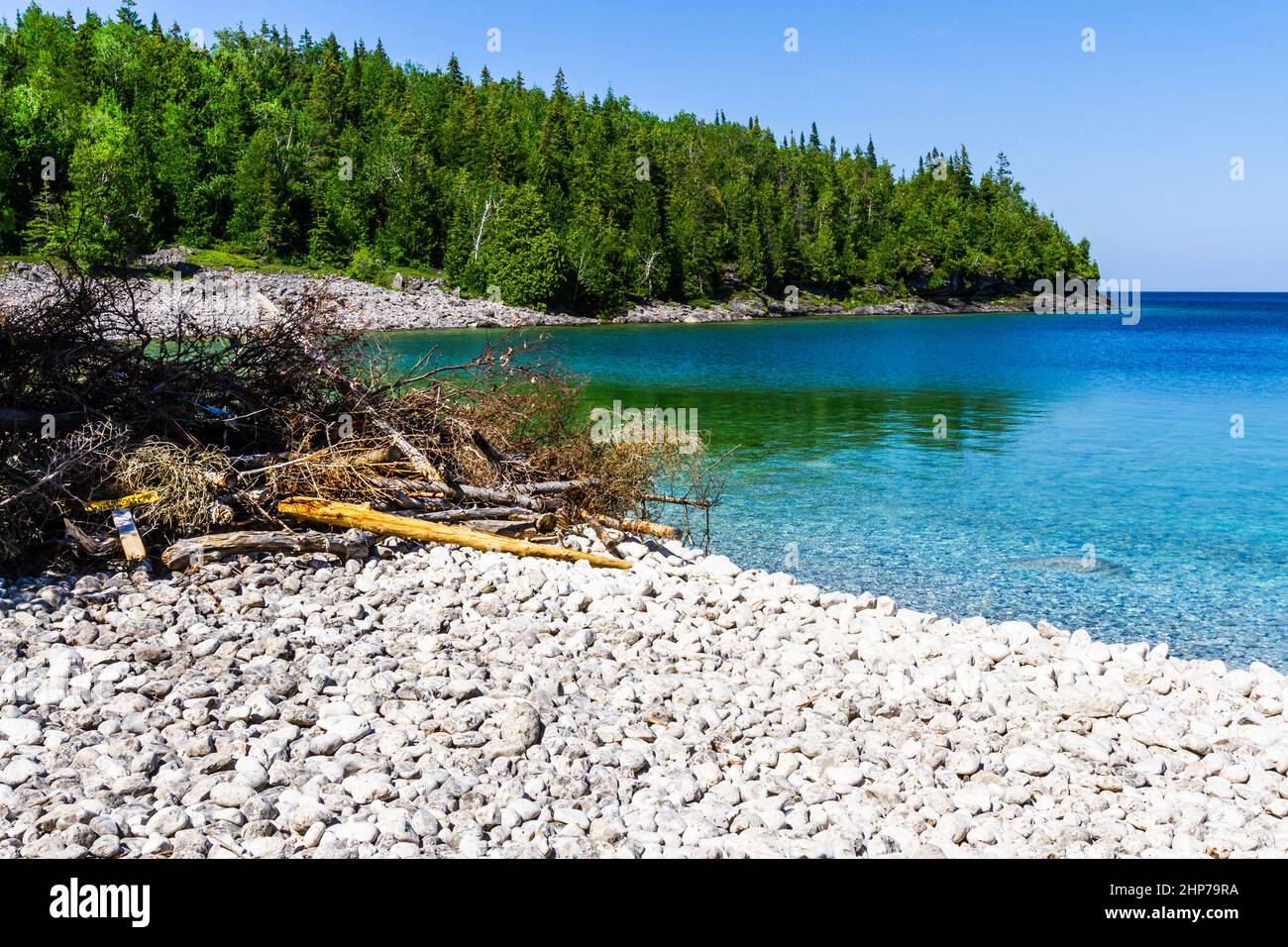 White, stony coastline lake Huron. Crystal clear water shows limestone ...