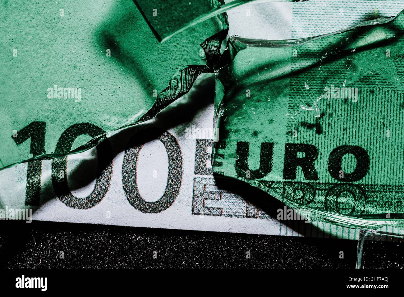 one hundred euro banknotes with green broken glass. financial crisis ...