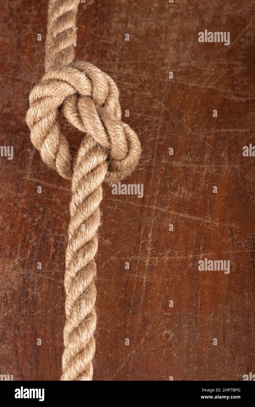 Rope with Reef Knot on Wood Texture Background Stock Photo - Alamy
