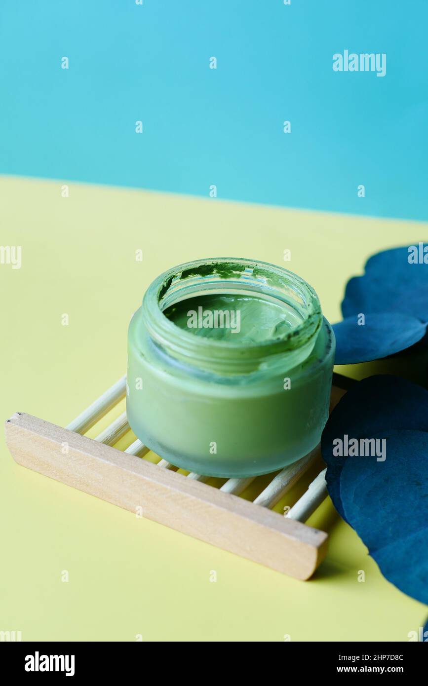 bubble clay mask in container on color background Stock Photo - Alamy