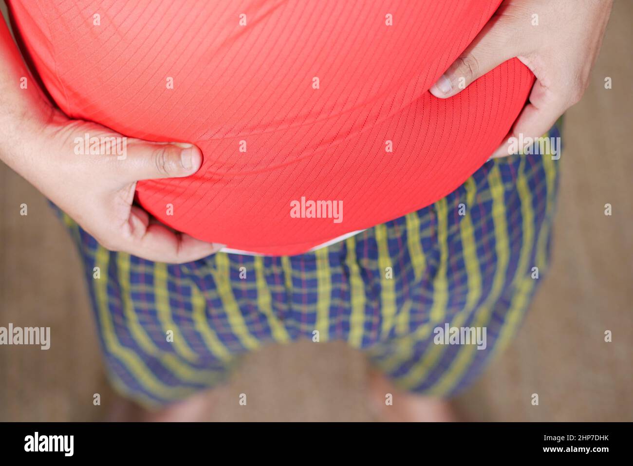 man's hand holding excessive belly fat, overweight concept Stock Photo ...