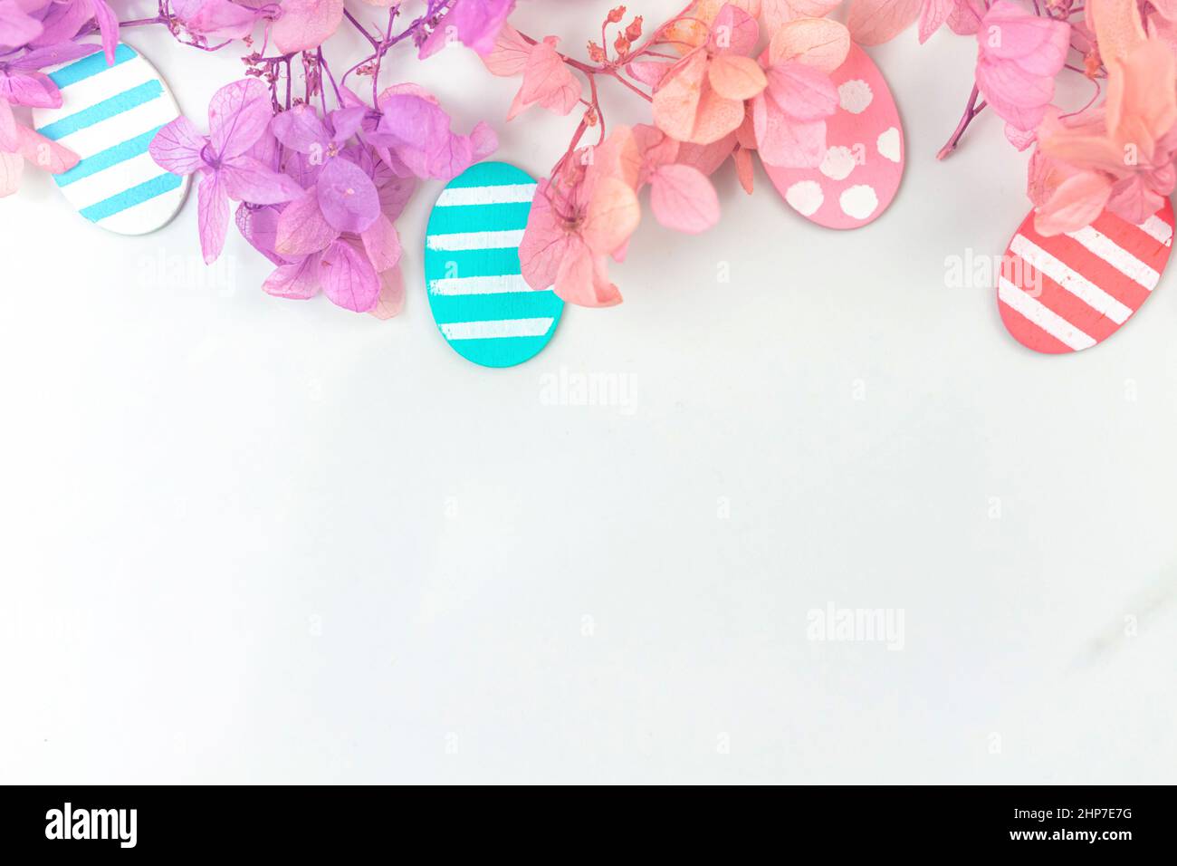 Colorful easter eggs and flowers. Border design with pink spring ...