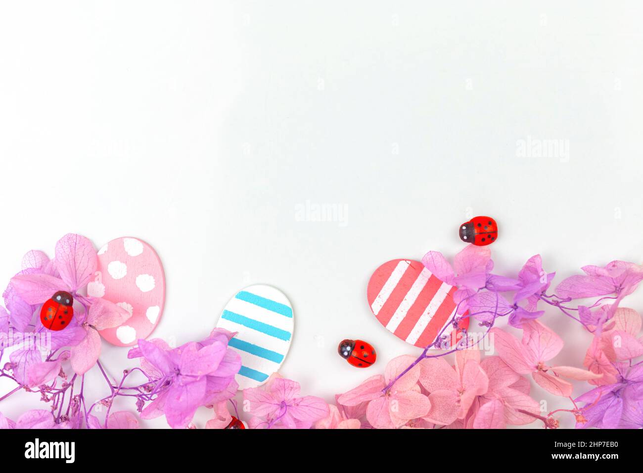 Colorful easter eggs and flowers. Bottom border design with pink spring ...
