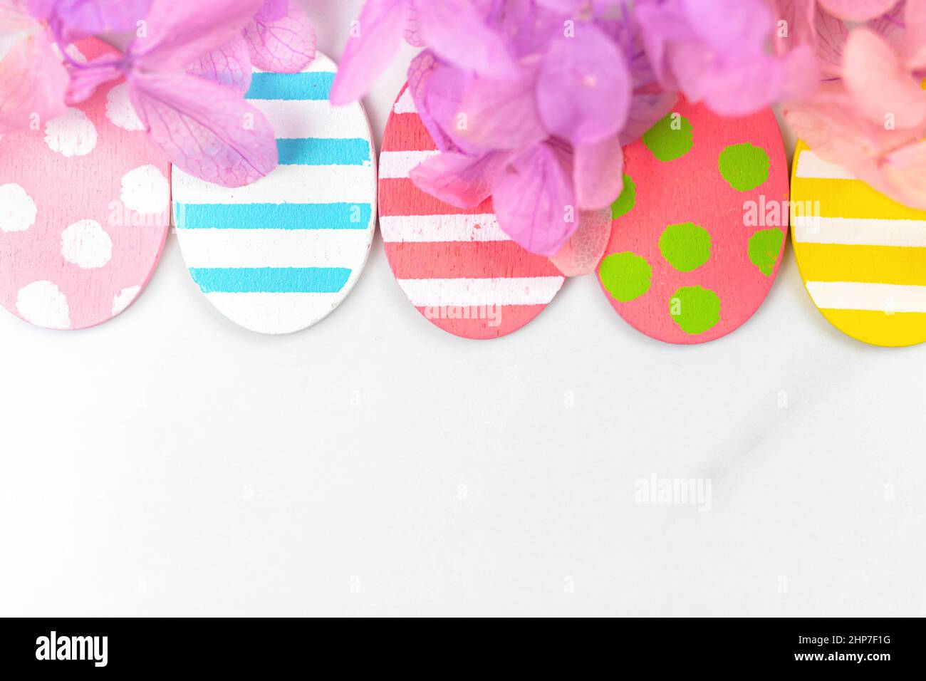 Colorful easter eggs and flowers. Border design with pink spring ...