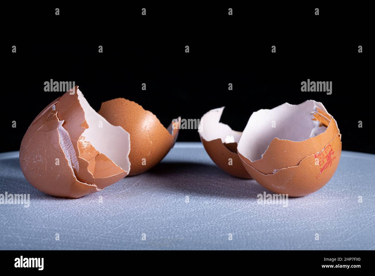 Broken Brown eggshells in a studio Stock Photo - Alamy