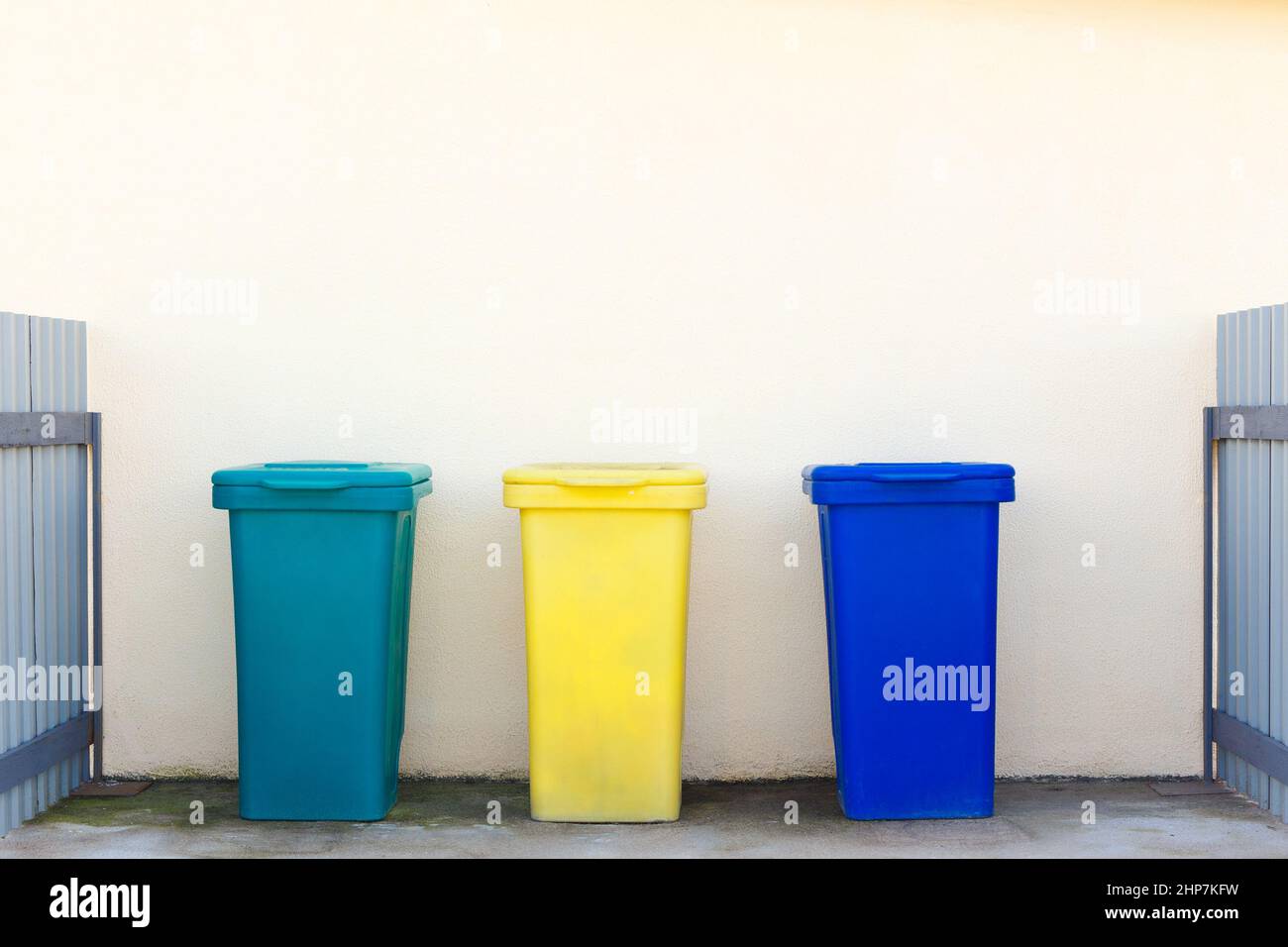 Colorful plastic containers in a row for separate garbage collection on ...