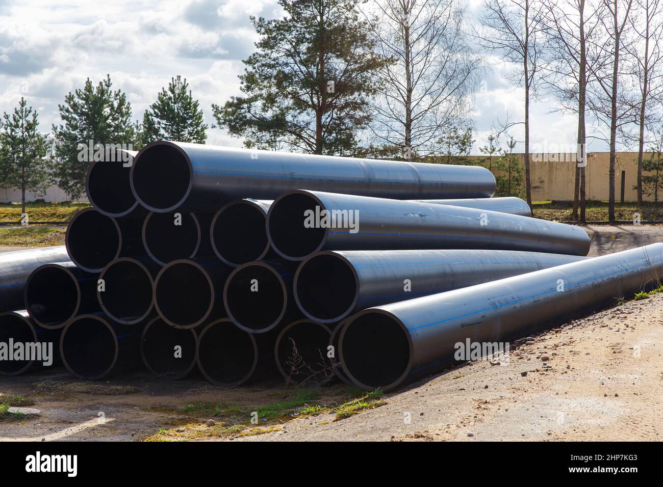HDPE pipe for water supply stacked on the platform under the open sky ...
