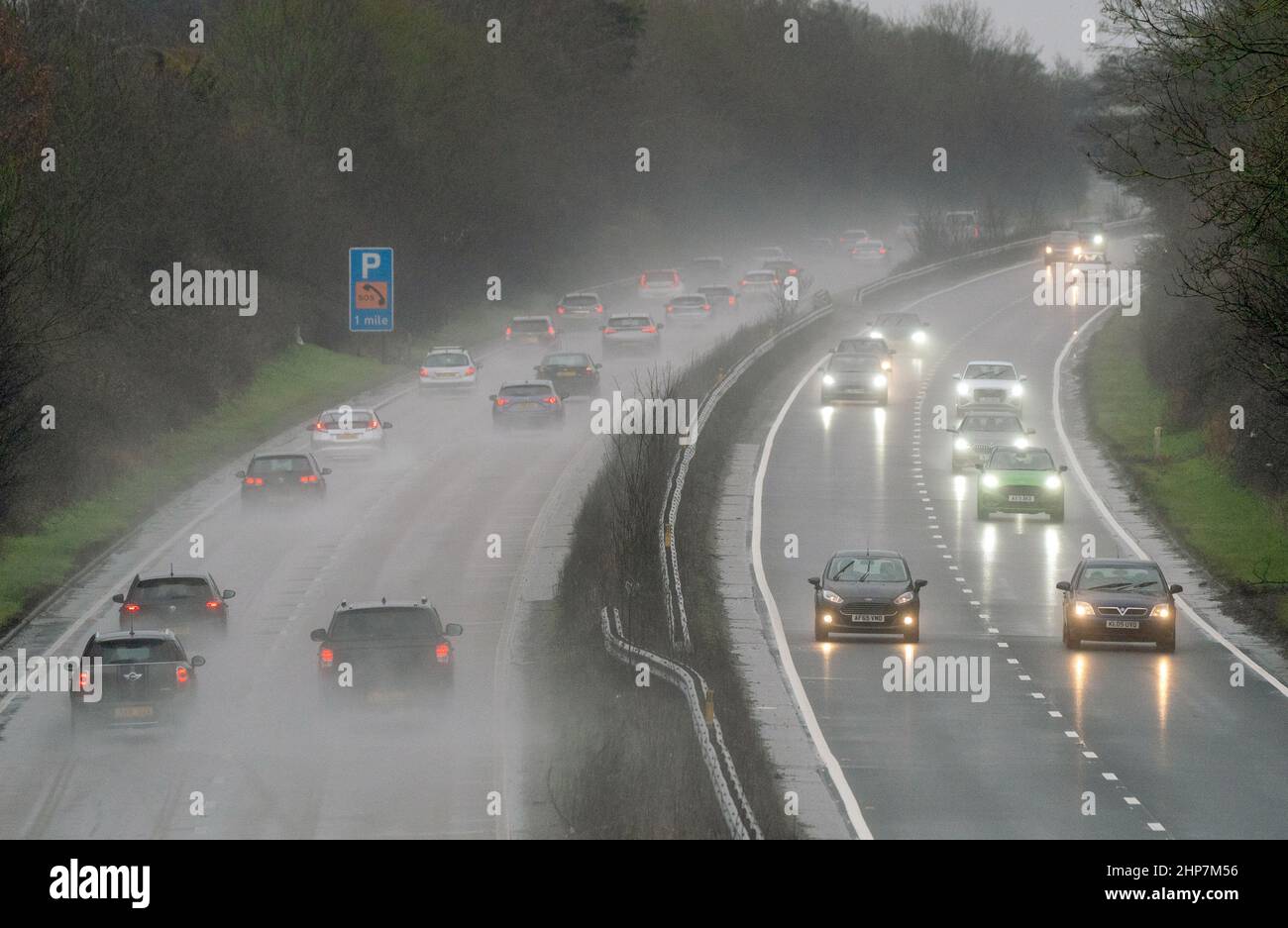 Cars make their way through heavy rain on the A14 in Suffolk, after ...