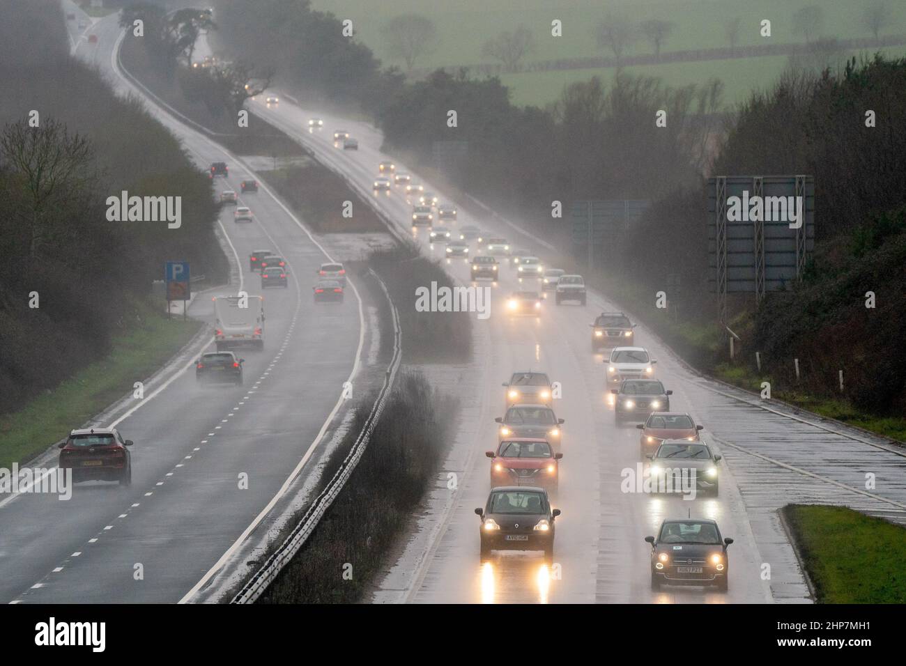 Cars make their way through heavy rain on the A14 in Suffolk, after ...
