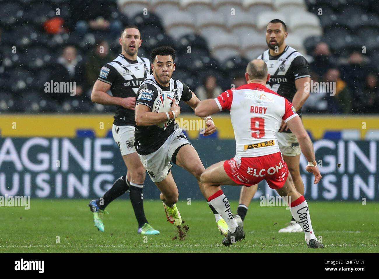 Darnell McIntosh (5) of Hull FC runs at James Roby (9) of St Helens ...